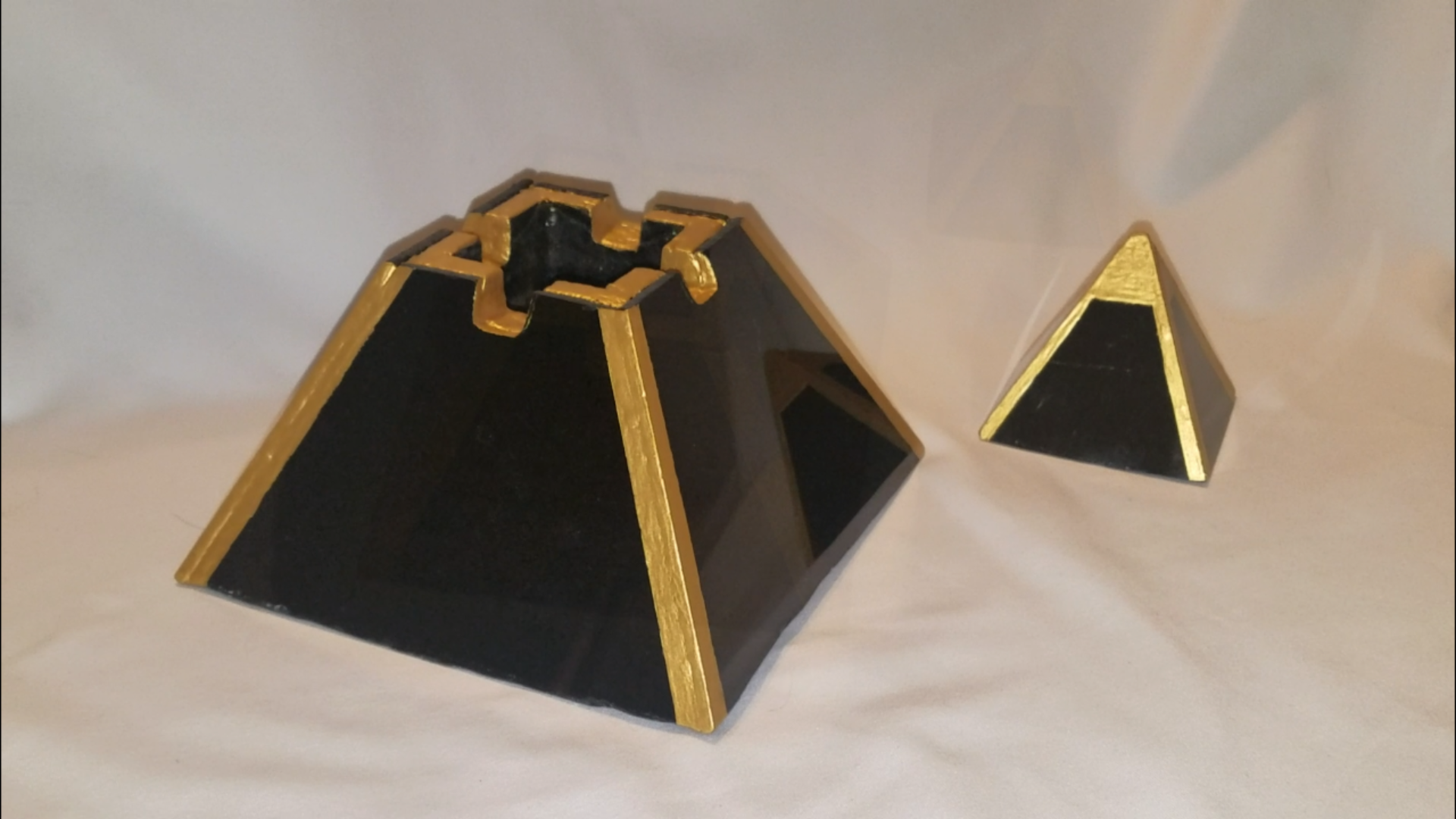 Gold Black Pyramid A Group Of Black Pyramids With Gold Detail
